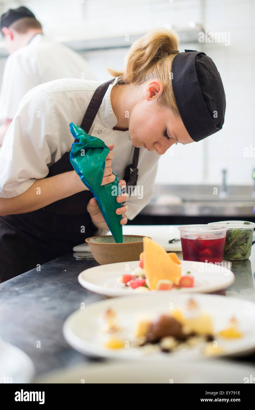 Hospitality and Catering UK: a young woman chef at work in a hotel ...