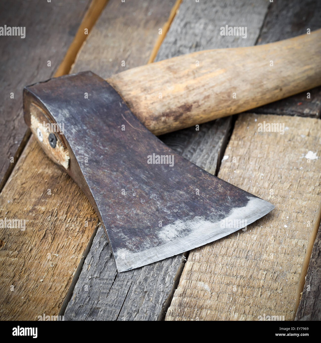 Axe on a wooden background, closeup Stock Photo - Alamy