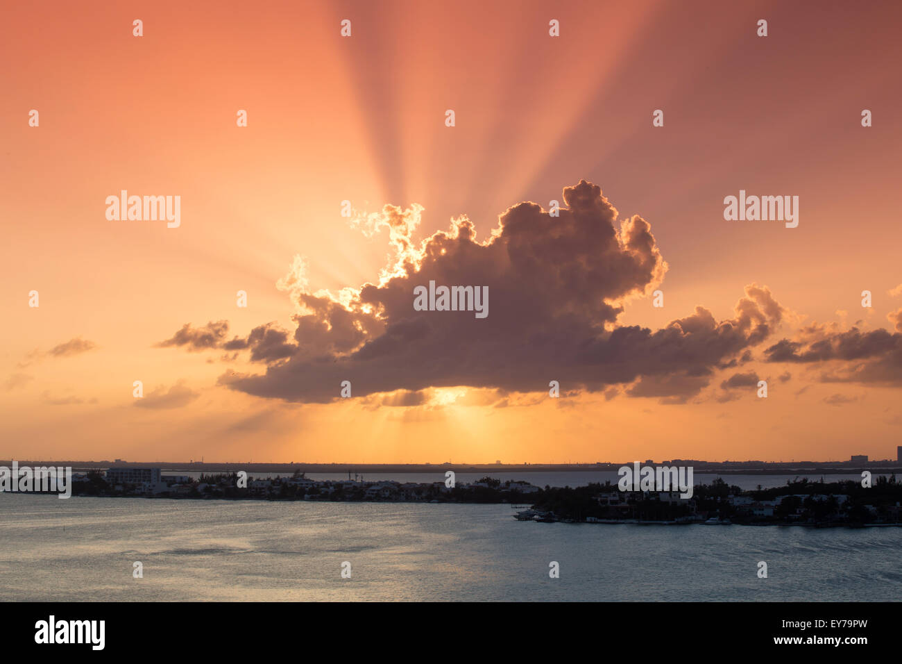 Beautiful sunset through clouds Stock Photo - Alamy