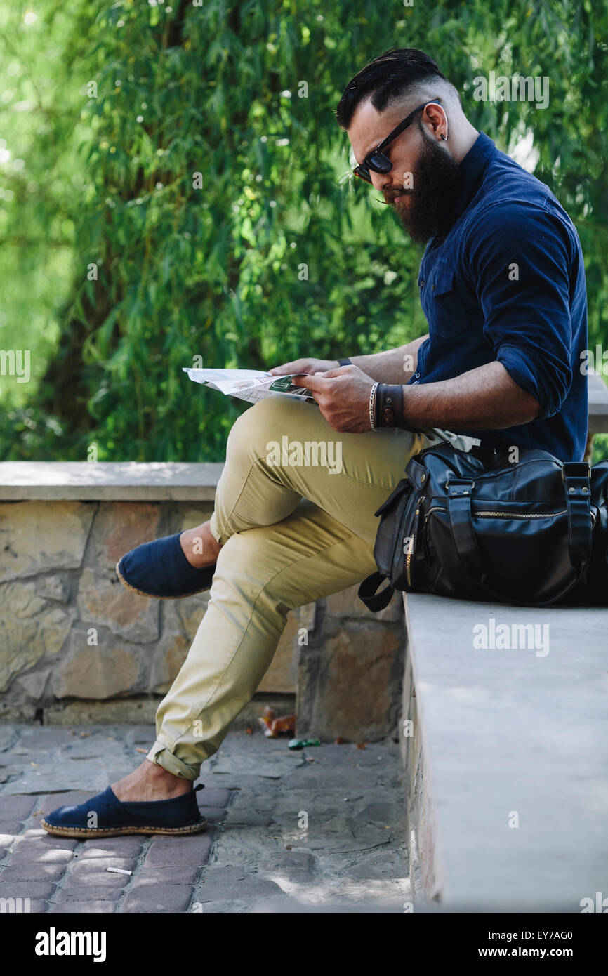 bearded man looking at a map Stock Photo - Alamy
