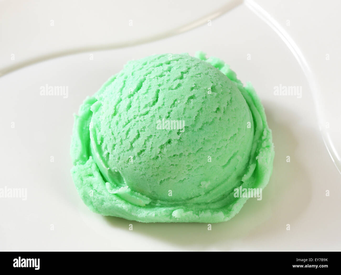 Scoop of green ice cream on plate Stock Photo - Alamy