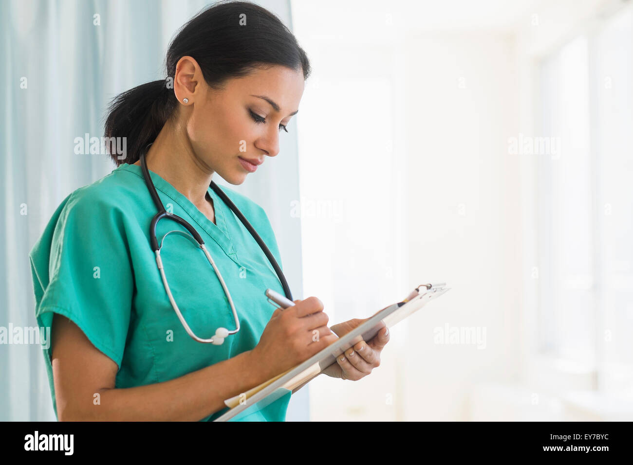 Female doctor making notes Stock Photo - Alamy