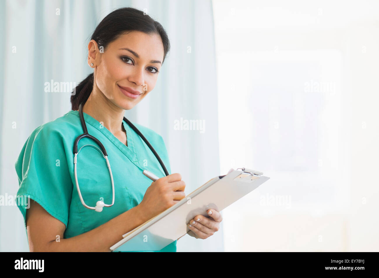 Female doctor making notes Stock Photo - Alamy