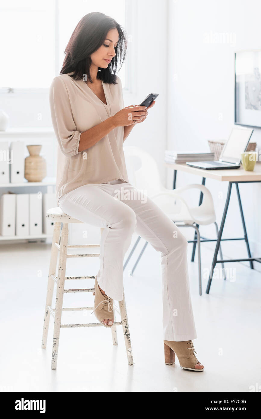Smart woman sitting on stool hi-res stock photography and images - Alamy