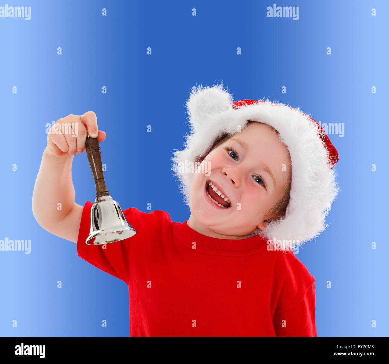 Cheerful boy ringing hand bell in front of him, blue background Stock ...
