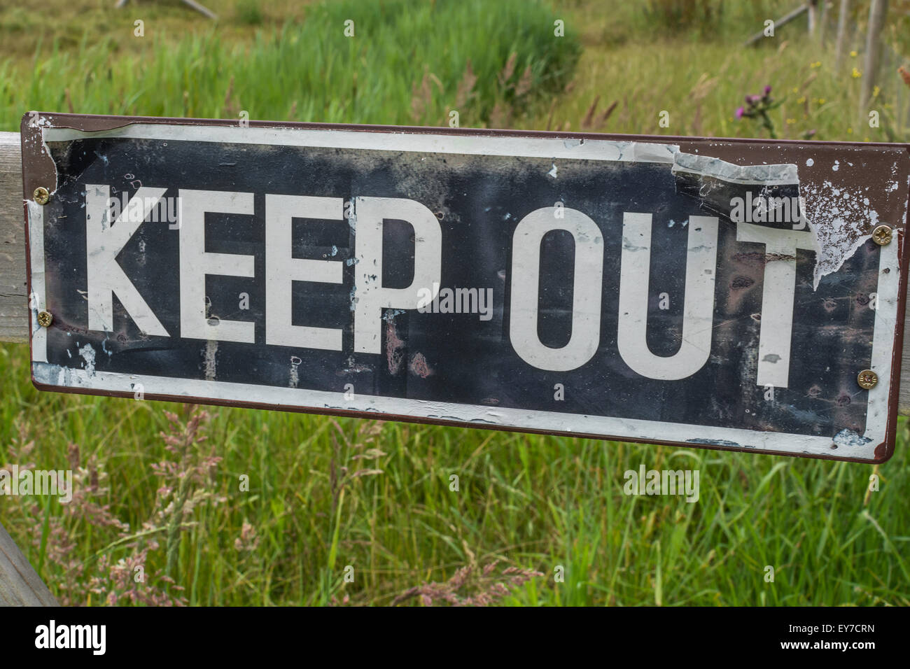 Warning sign - Keep Out - on gate. Metaphor for 'obey', closed meeting ...