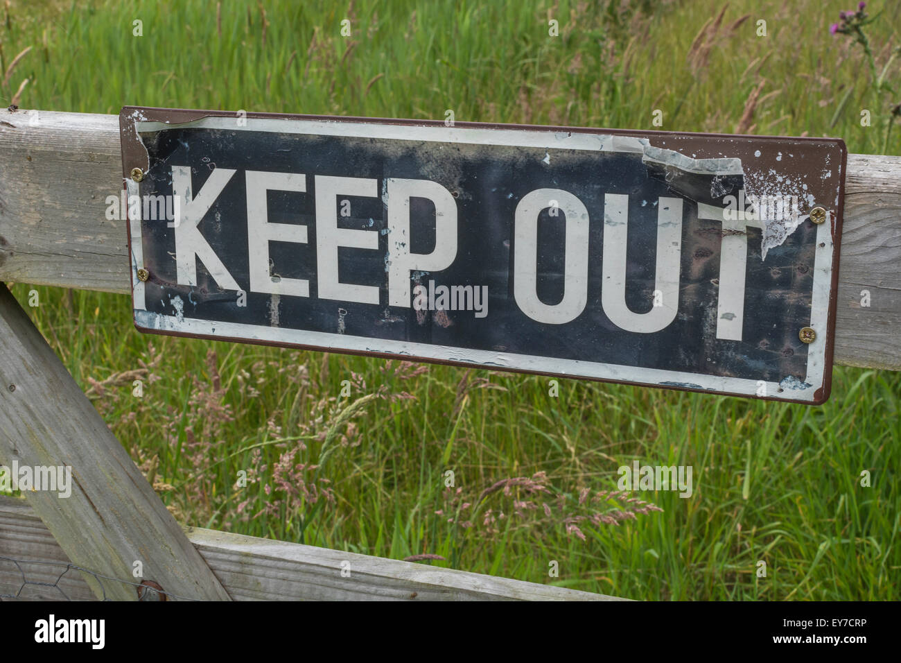 Warning sign - Keep Out - on gate. Metaphor for 'obey', closed meeting ...