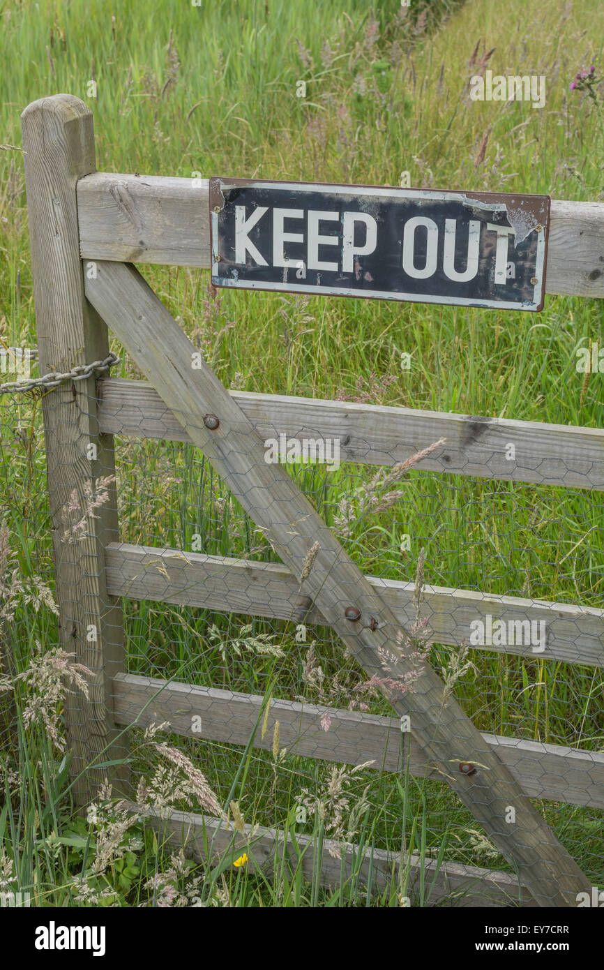 Warning sign - Keep Out - on gate. Metaphor for 'obey', closed meeting ...