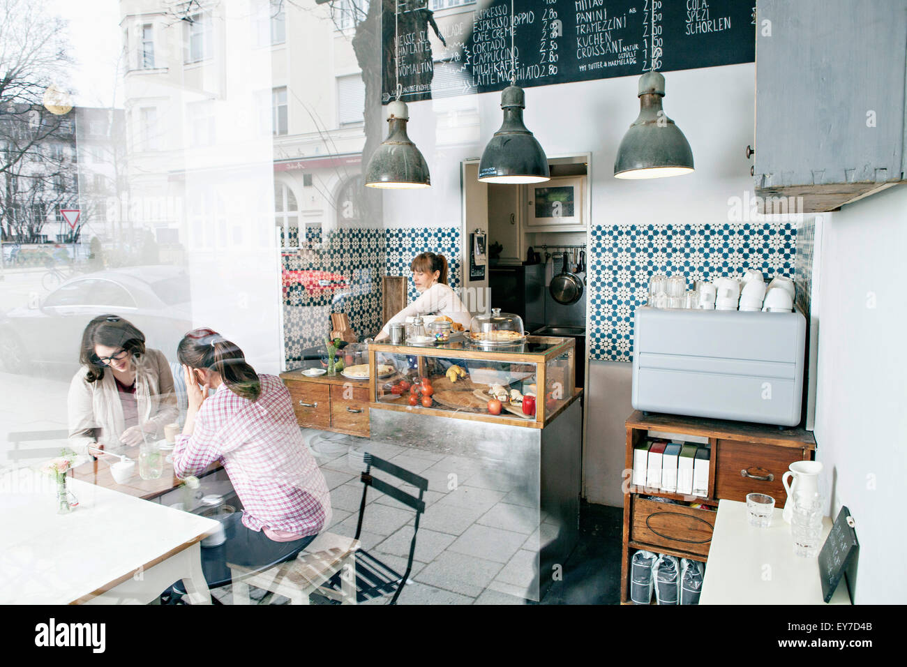 Guests and waitress in cafe Stock Photo - Alamy