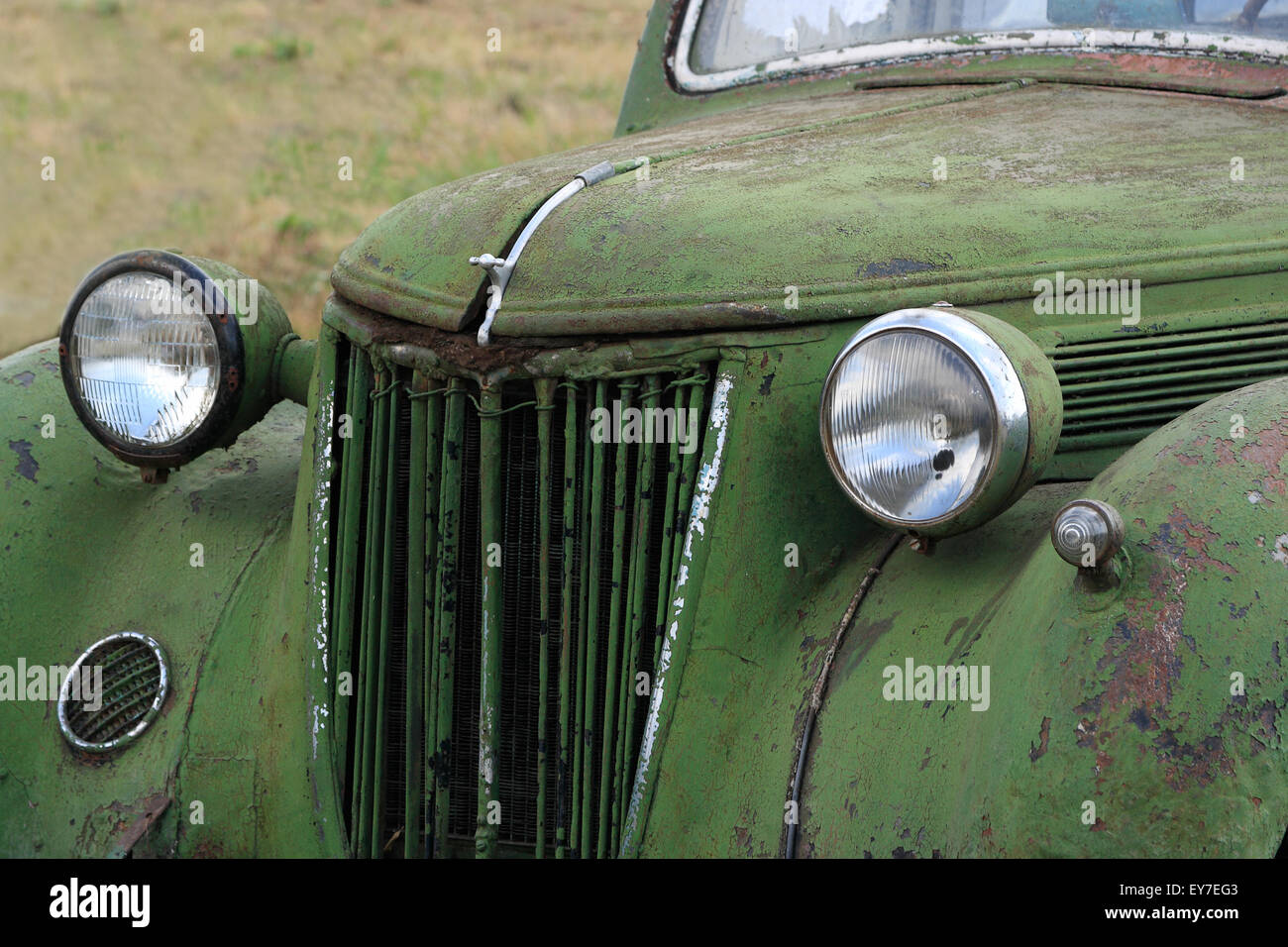 Old rusty vintage car in a field Stock Photo - Alamy