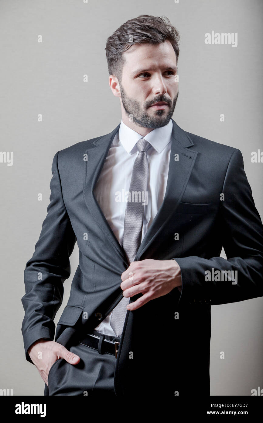 Businessman buttoning suit jacket Stock Photo - Alamy