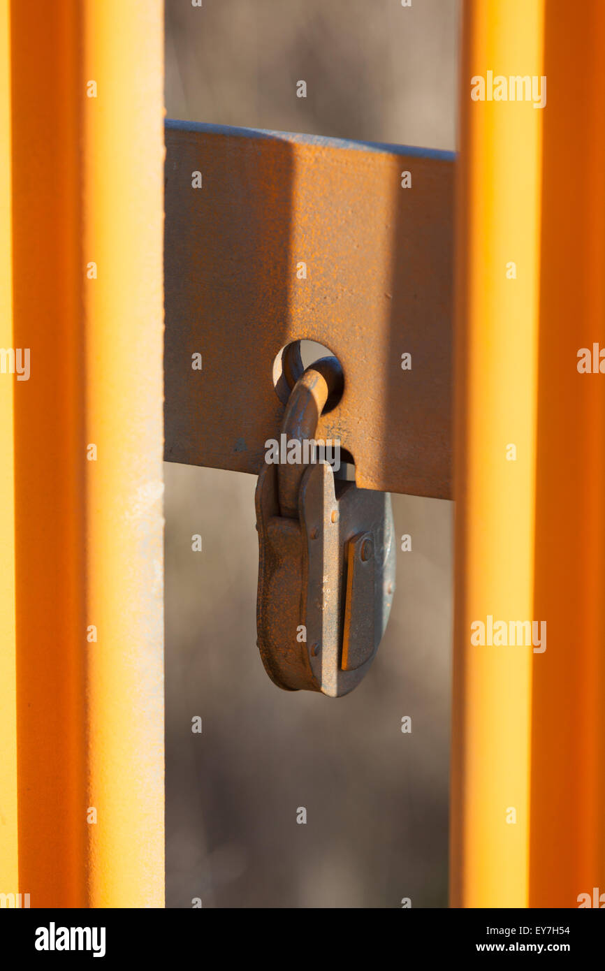 A padlocked access gate on the side of a railway line in the UK. F ...