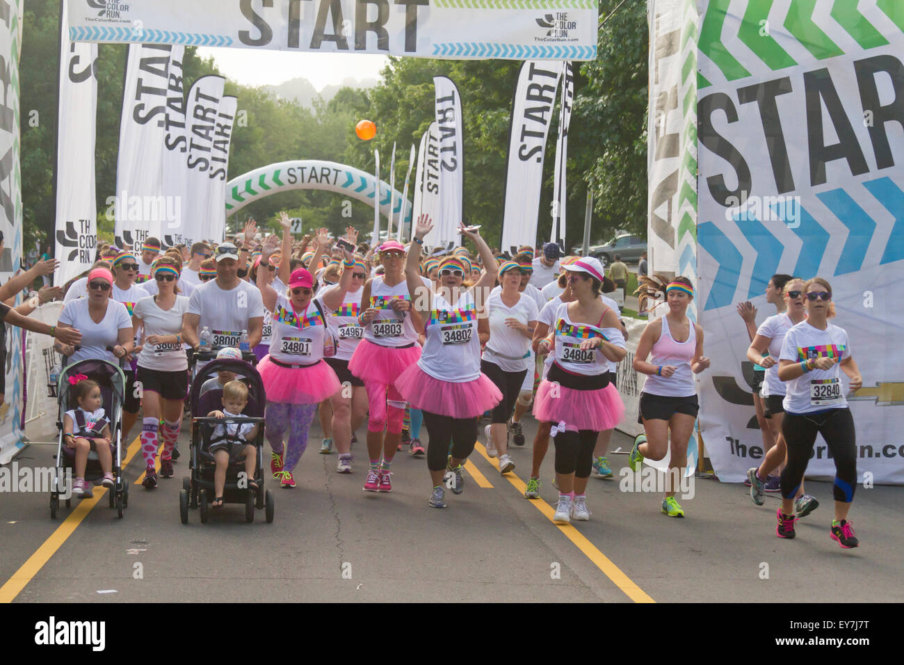 Happy Color Run Runners wearing colorful tutus and headbands and ...