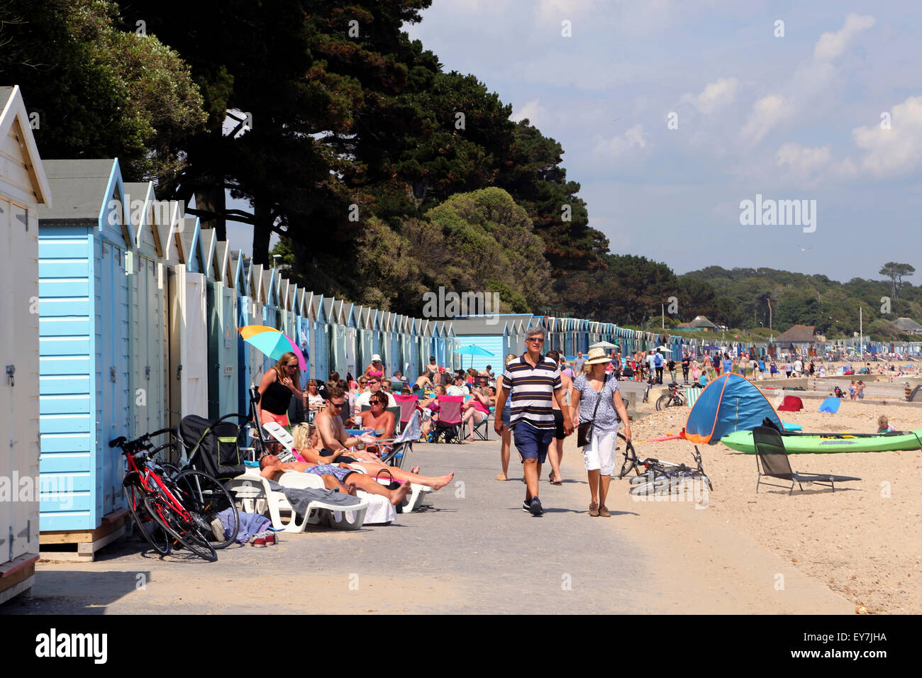 Sunbathers Outside Beach Huts On Avon Beach Mudeford Dorset England ...
