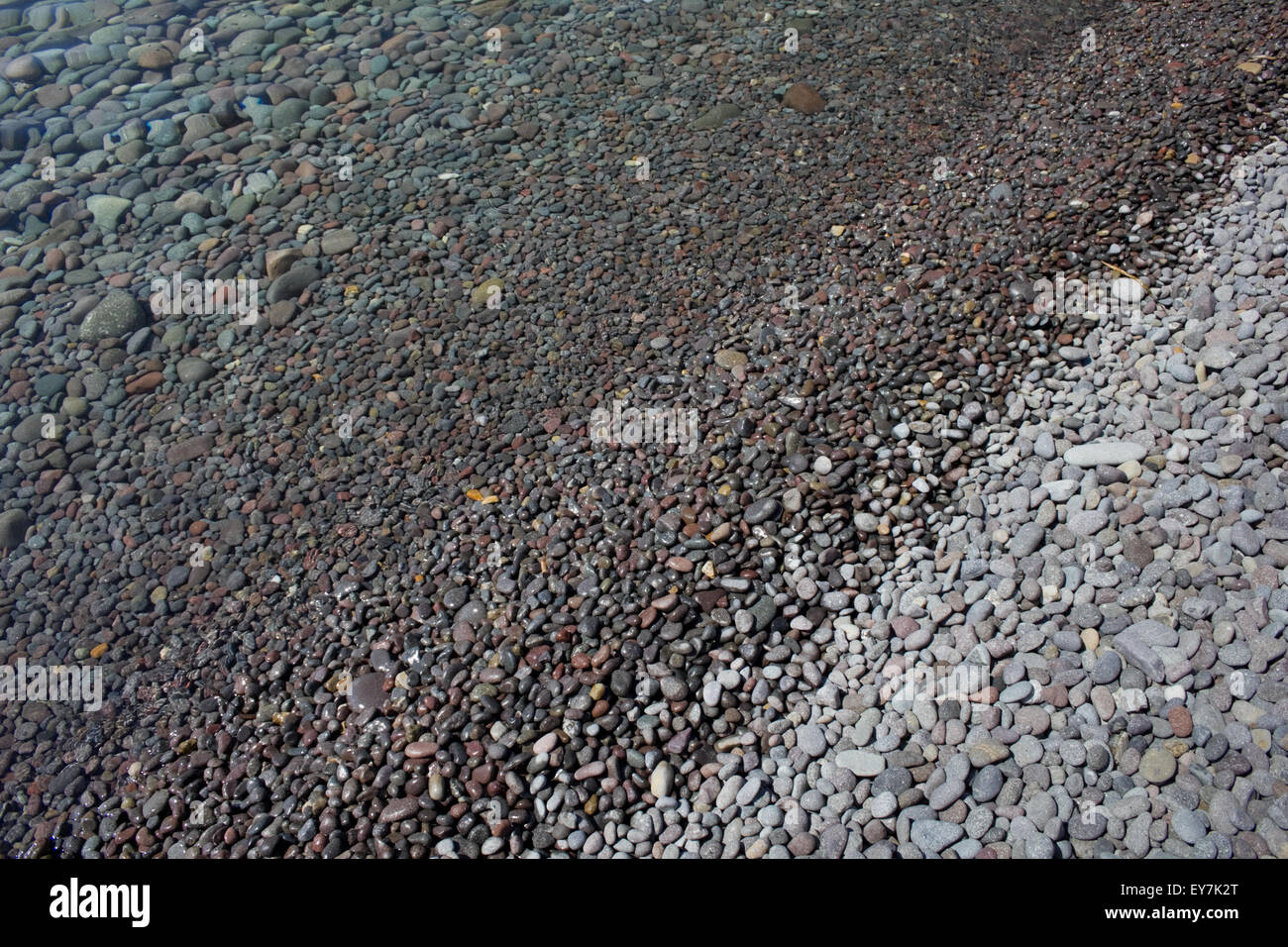 Limpid sea waters and peebly seaside of Small Mourouli beach. Agios ...