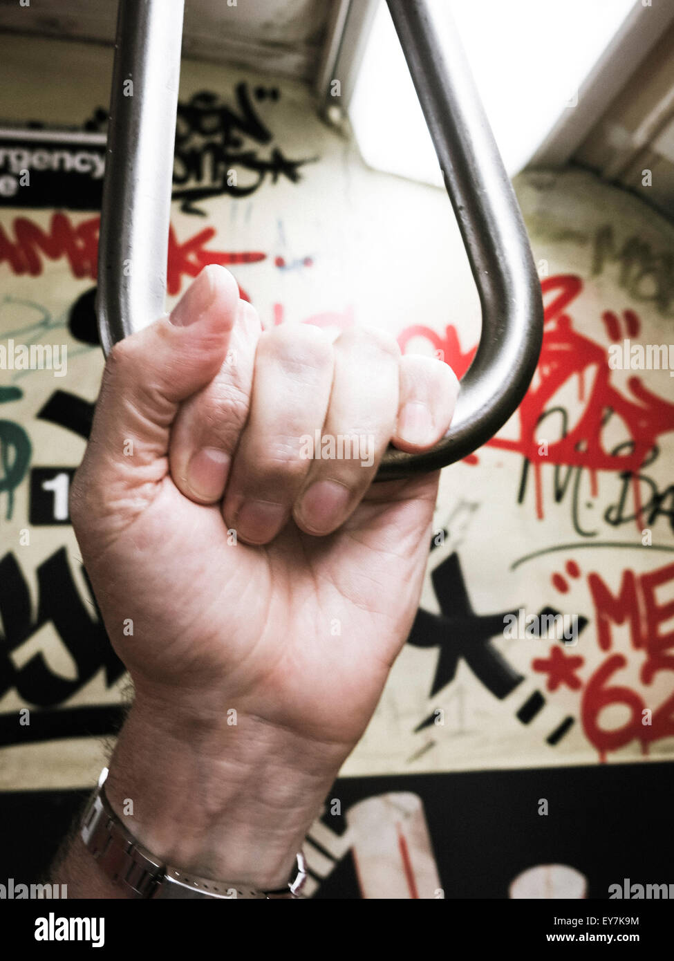 Man's hand holding a pivoted grab handle on a New York City vintage ...