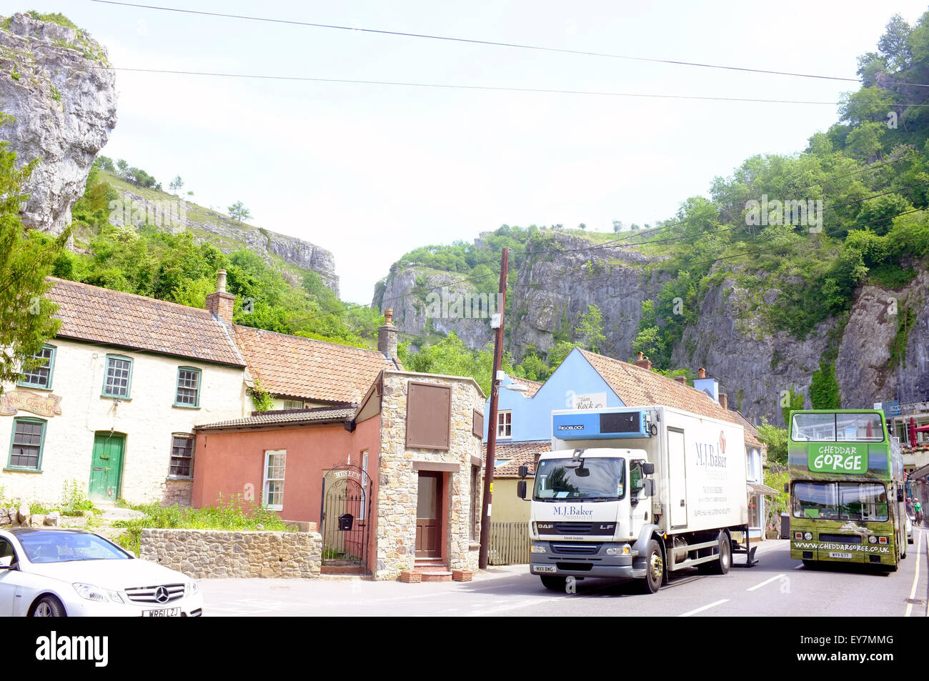 A lorry and a double decker tourist bus in the village of Cheddar by ...