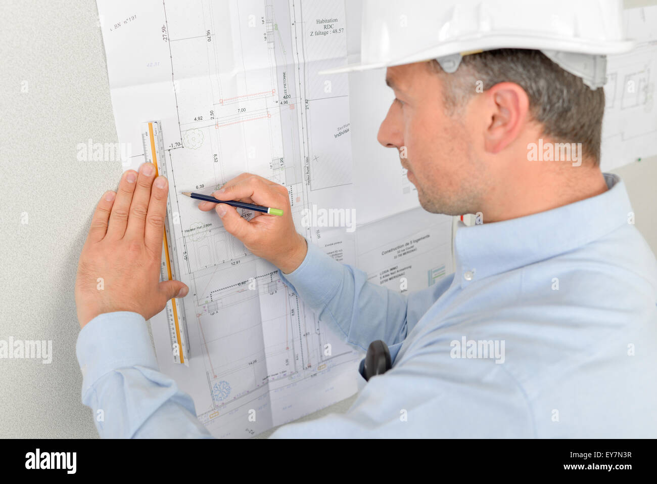 Architect writing on his blue prints Stock Photo - Alamy