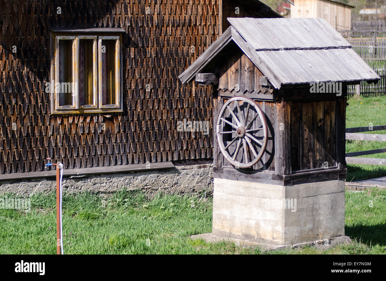 Countryside House Rustic wooden well beside traditional house in a ...