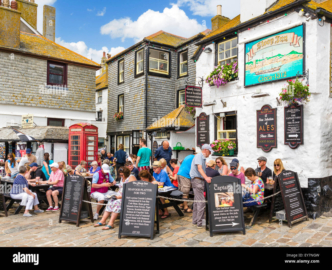 People sitting outside the historic Sloop in on the seafront, Wharf ...