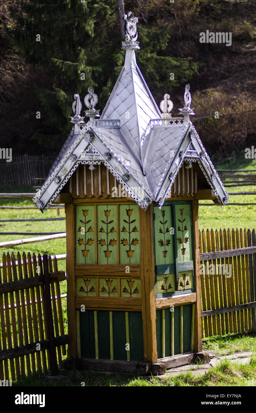 Countryside House Rustic wooden well beside traditional house in a ...