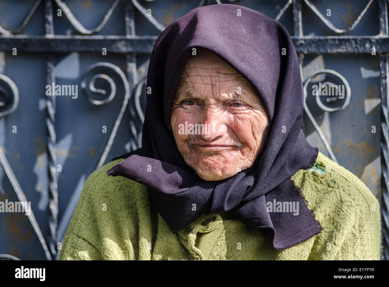 Old woman romanian countryside Elderly woman waves cheerfully from her ...