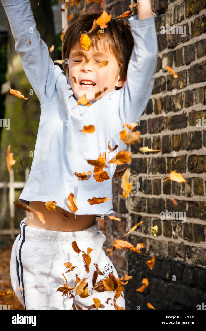 Caucasian child, boy enjoying himself in a road by wall, by taking ...