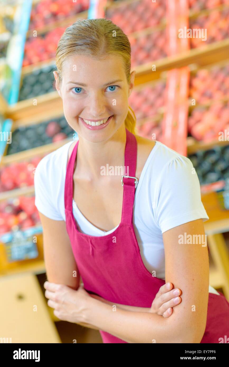 Smiling shop assistant in grocery store Stock Photo - Alamy