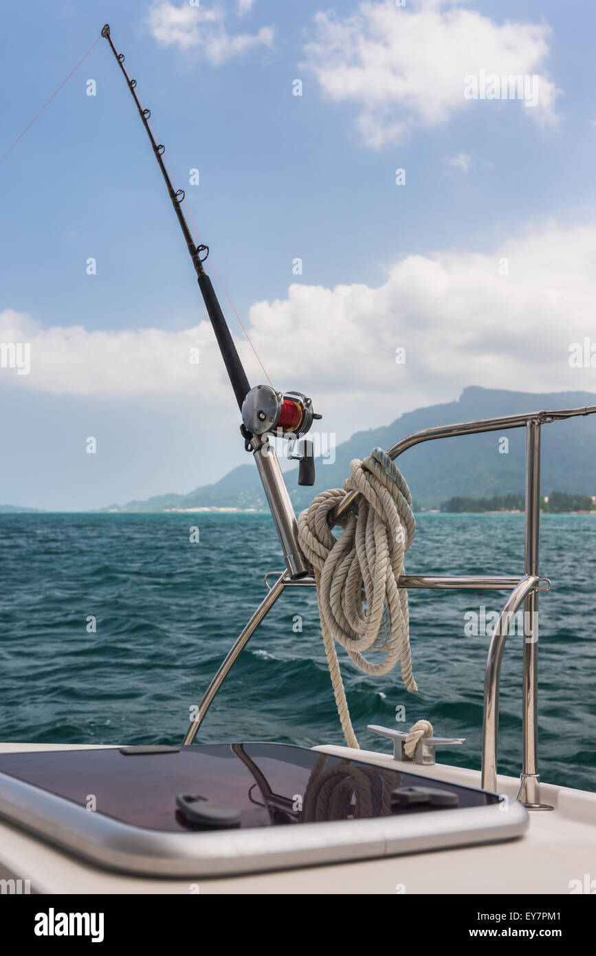 Fishing rod and reel on a sailing yacht. Vertical shot Stock Photo - Alamy