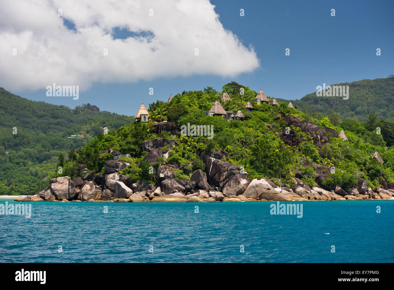View of Seychelles coastline with houses in the forest. Horizontal shot ...