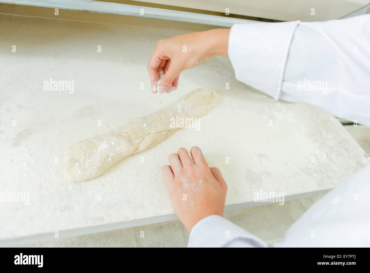 Dusting a baguette with flour Stock Photo - Alamy