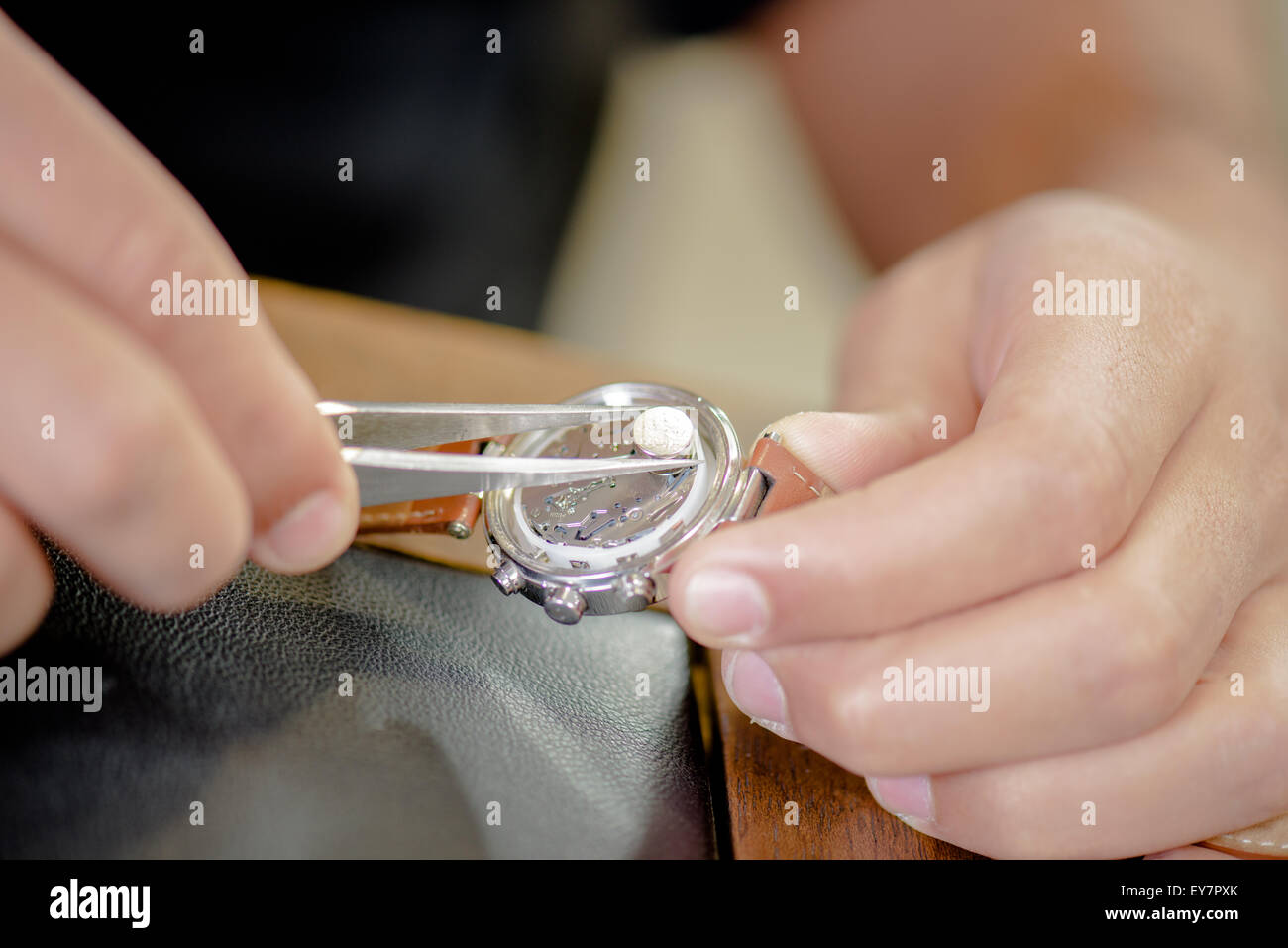 Fitting a watch battery Stock Photo - Alamy