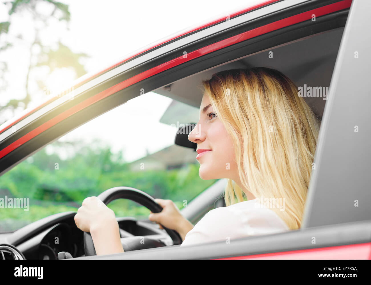 Woman in red car Stock Photo - Alamy