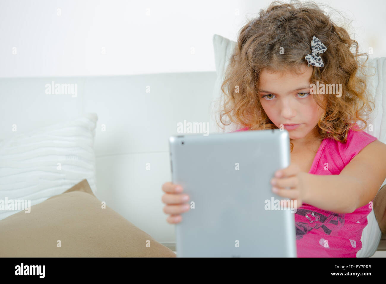 Little girl using a tablet computer Stock Photo - Alamy