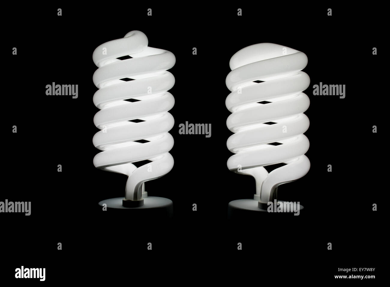 Two low energy spiral light bulbs illuminated Stock Photo - Alamy