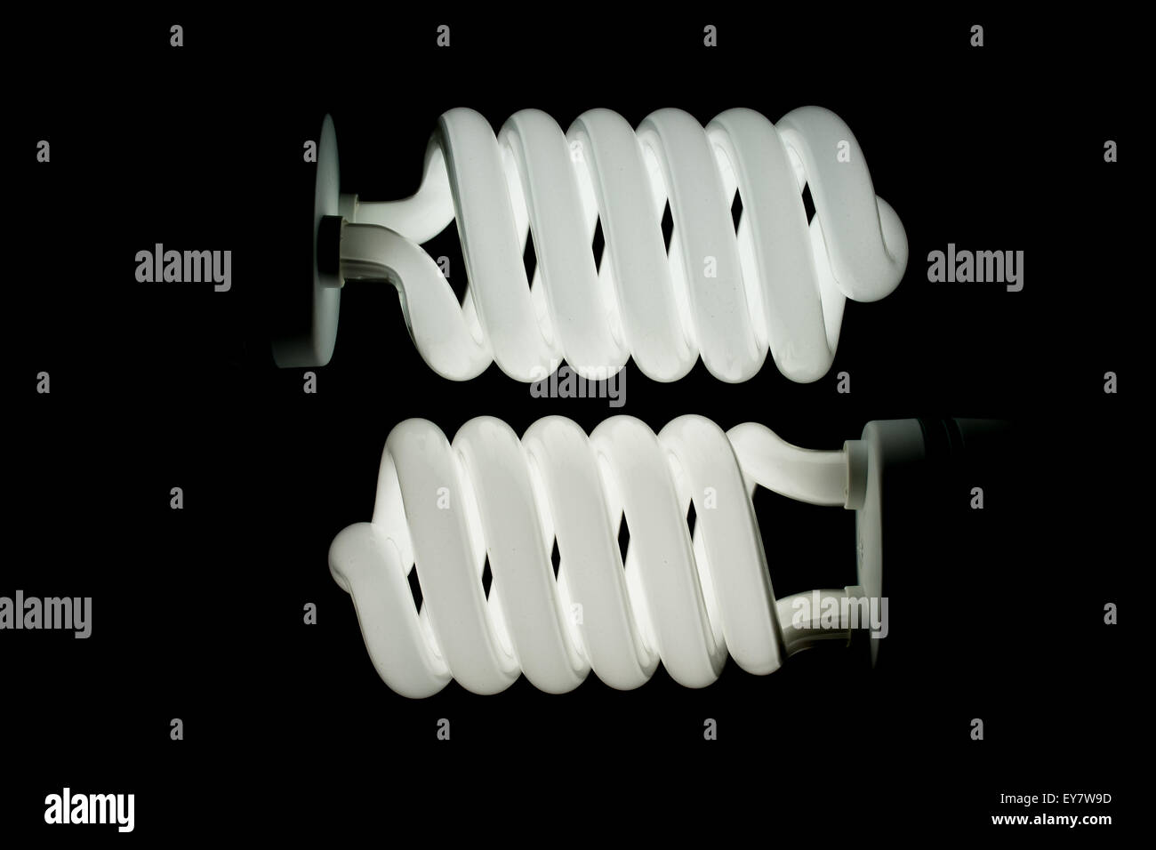 Two low energy spiral light bulbs illuminated Stock Photo - Alamy
