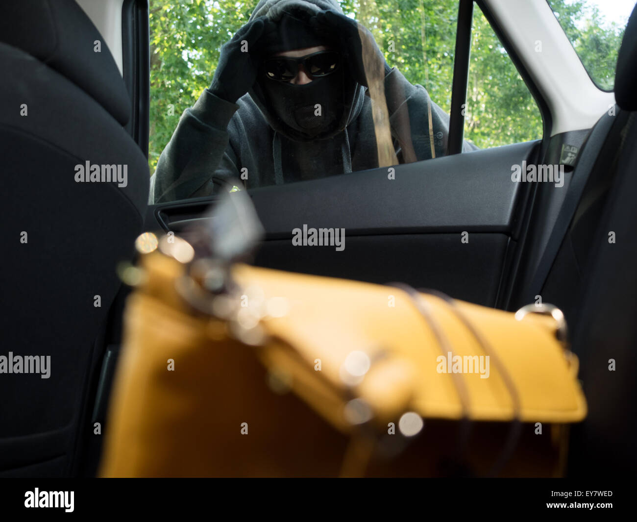 Transportation crime concept .Thief stealing bag from the car Stock ...