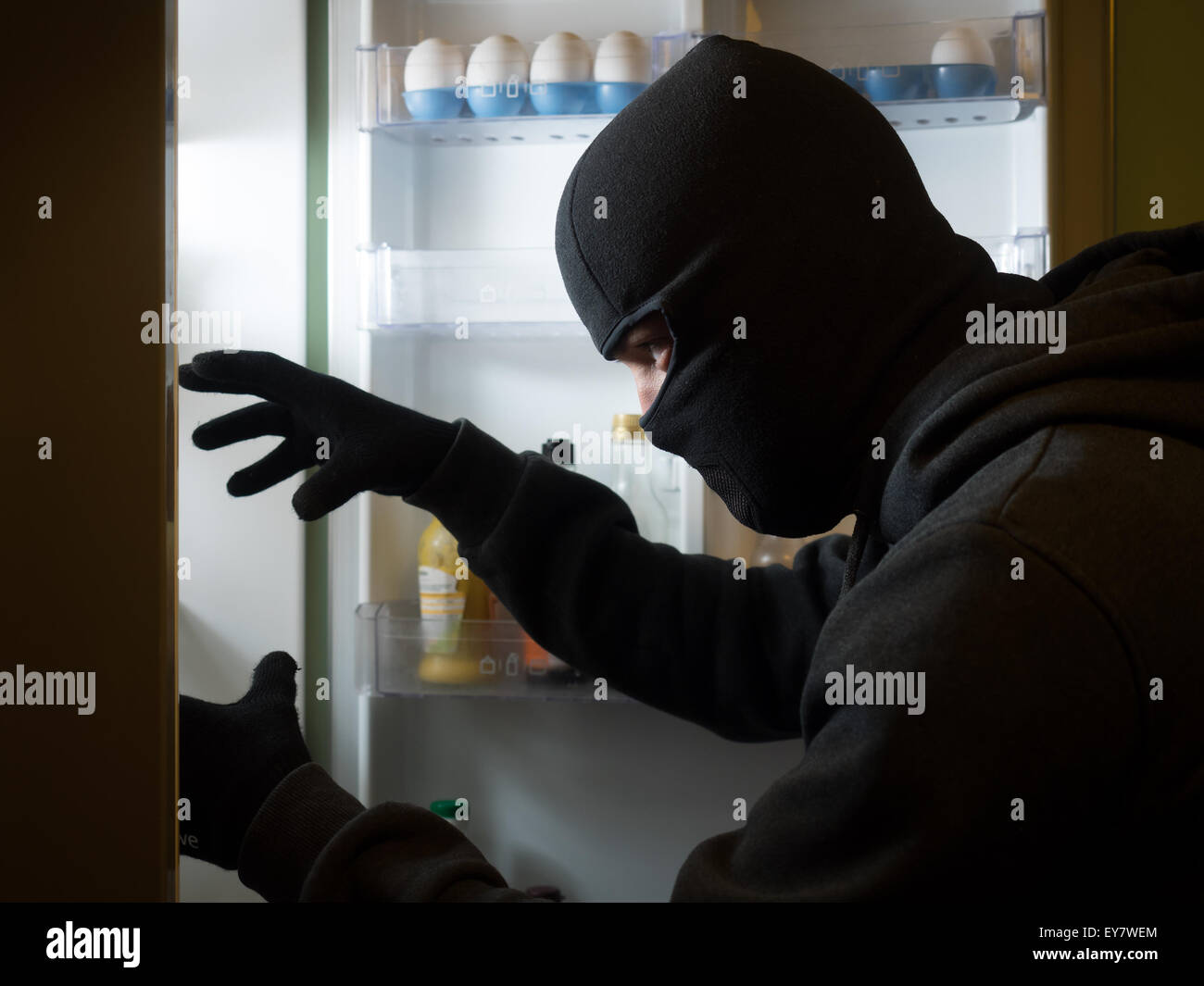 Thief. Man in black mask with a cake Stock Photo - Alamy