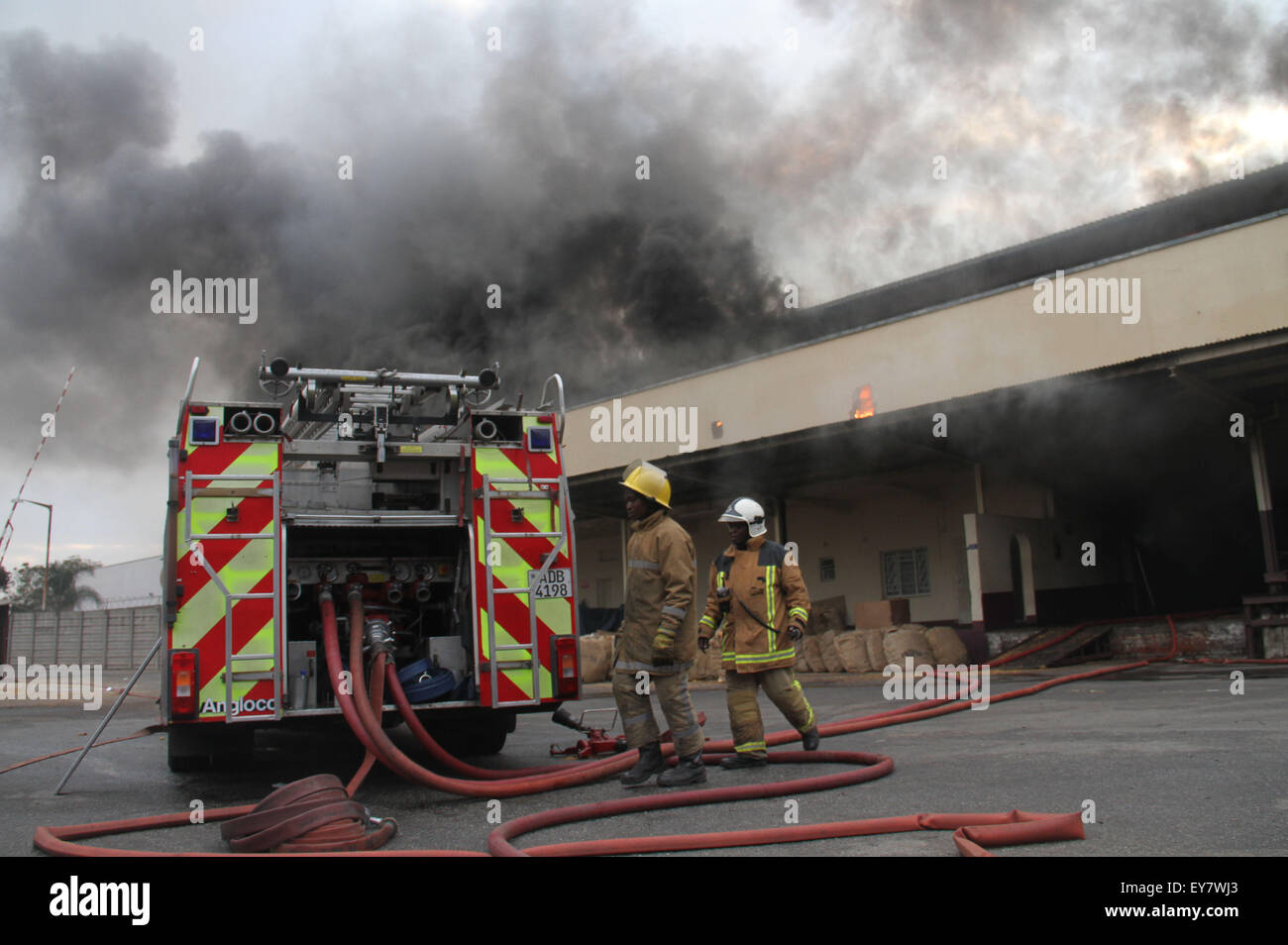 Harare, Zimbabwe. 23rd July, 2015. Firemen try to put off a fire at the ...