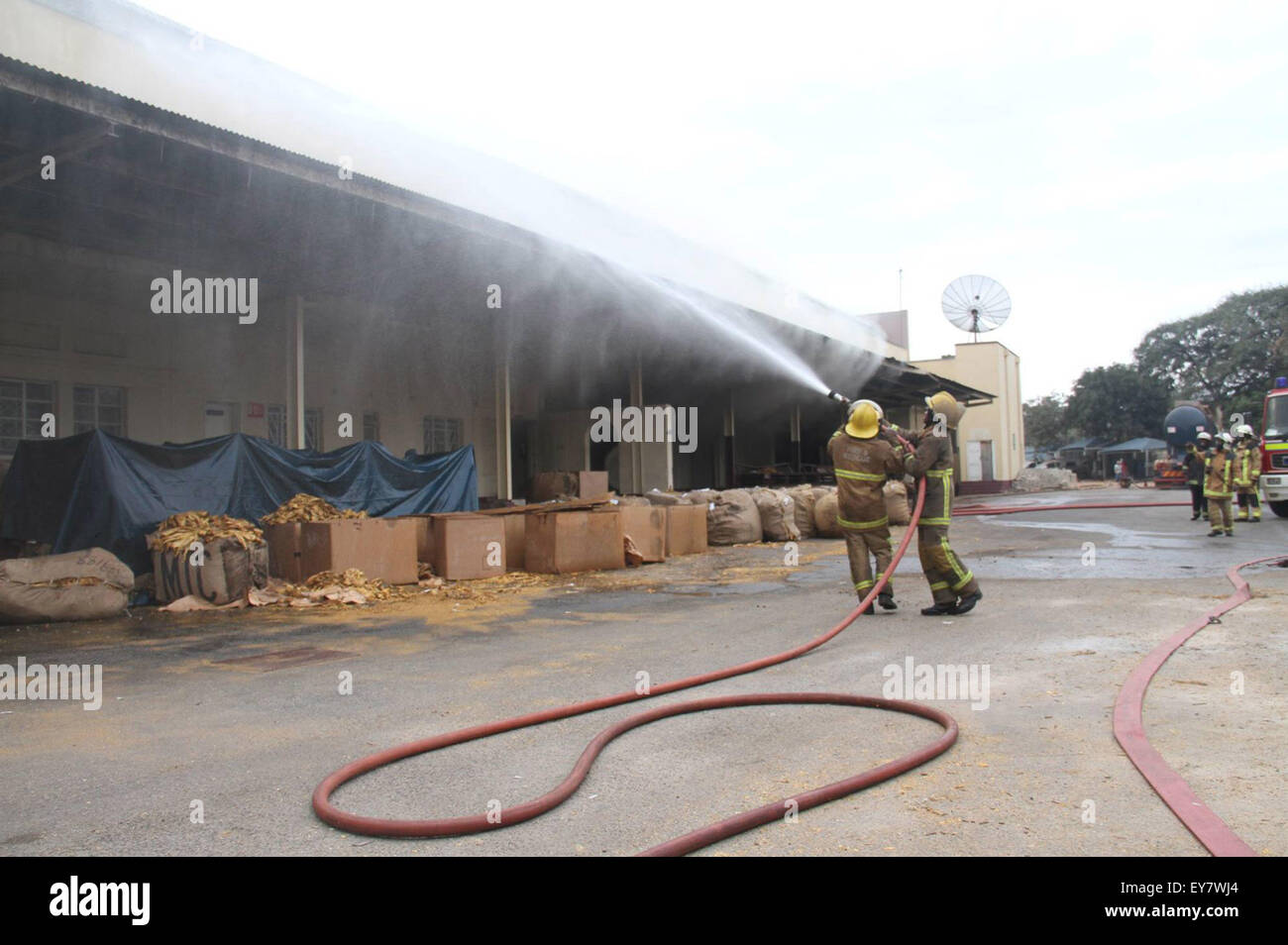 Harare, Zimbabwe. 23rd July, 2015. Firemen try to put off a fire at the ...