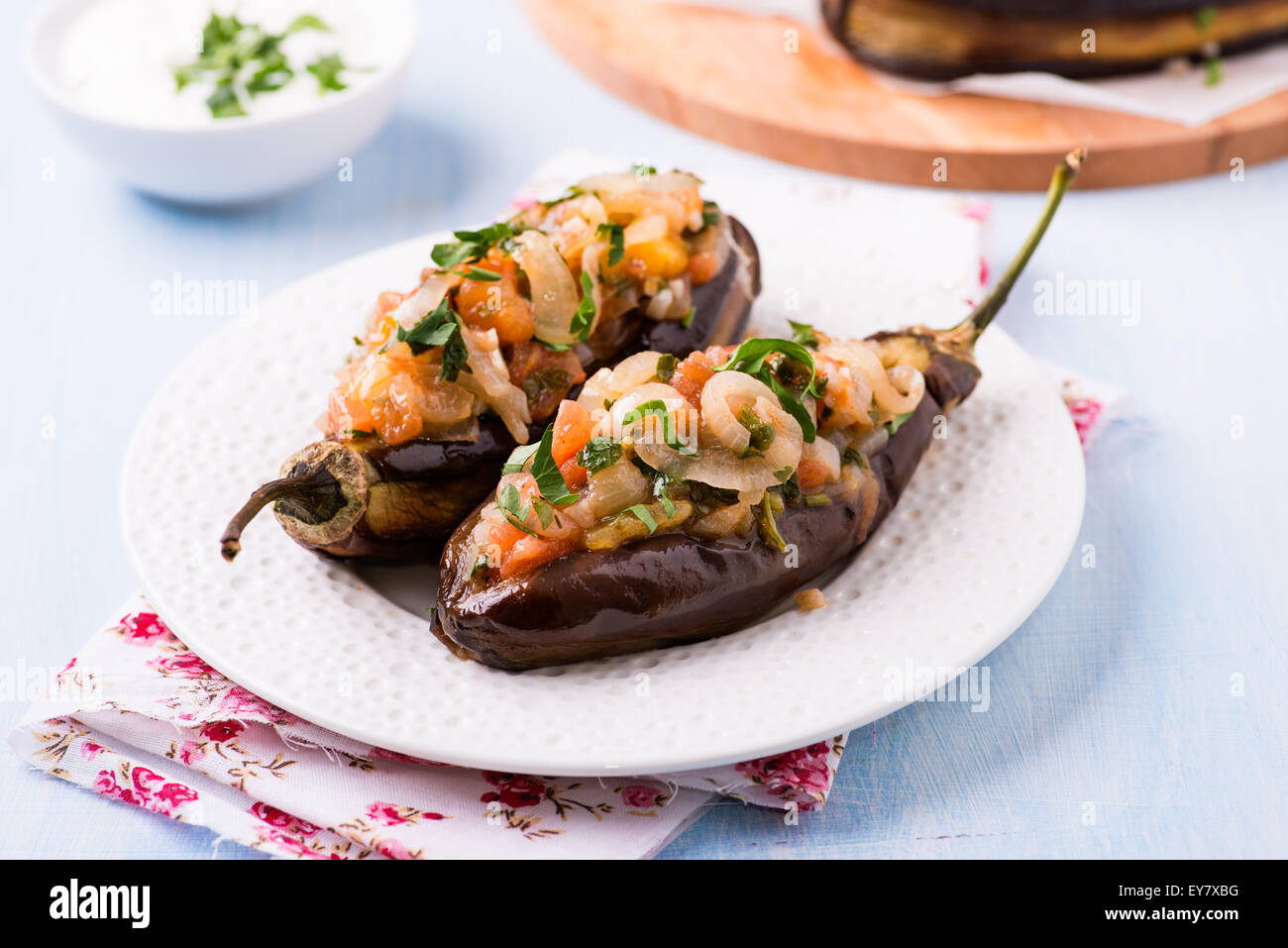 Imam Bayildi. Eggplants stuffed with vegetables on white plate. Turkish ...
