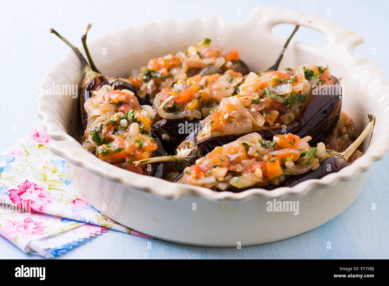 Imam Bayildi. Eggplants stuffed with vegetables in a baking tray ...