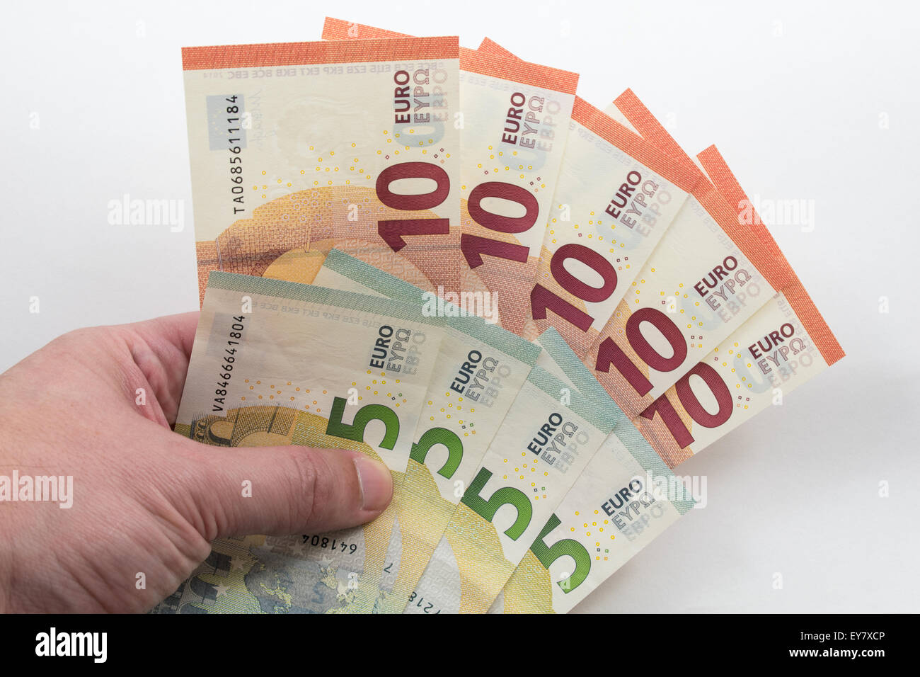 Hand holding 5 and 10 Euro notes Stock Photo - Alamy