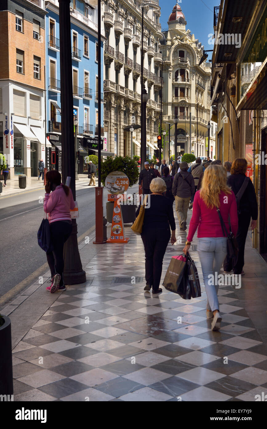 Pedestrians on the marble sidewalk of Catholic Kings street Granada ...