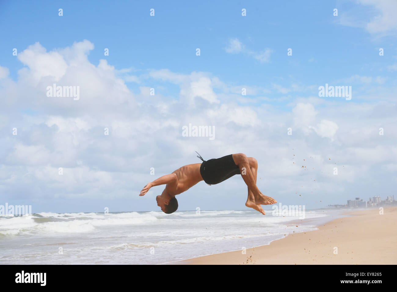 Man jumping on the beach, Salvador, Brazil Stock Photo - Alamy