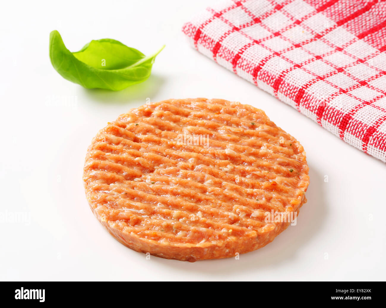 Raw burger patty - studio shot Stock Photo - Alamy