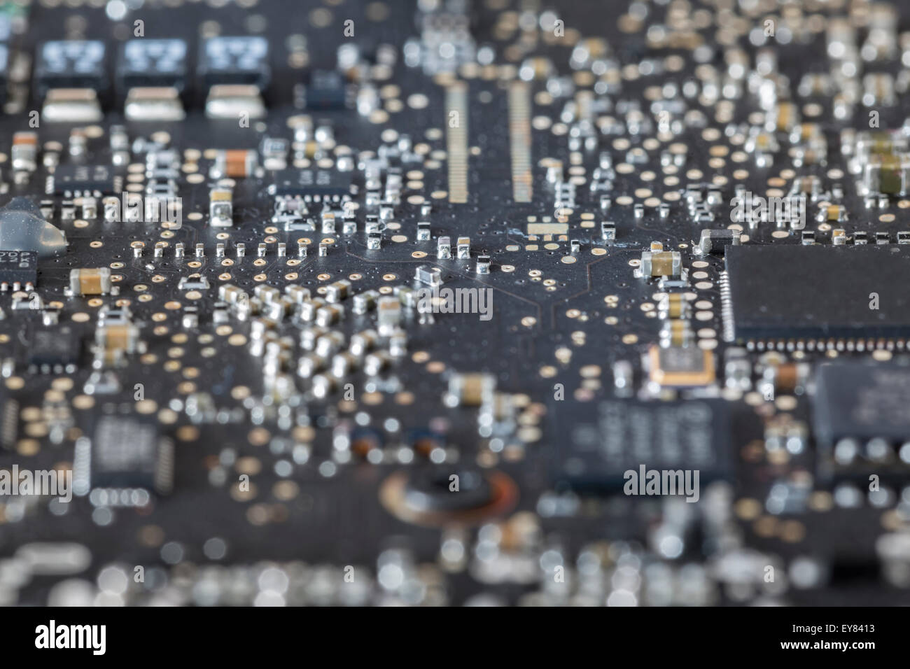 Detail view of condensers and microchips on a black mainboard Stock ...