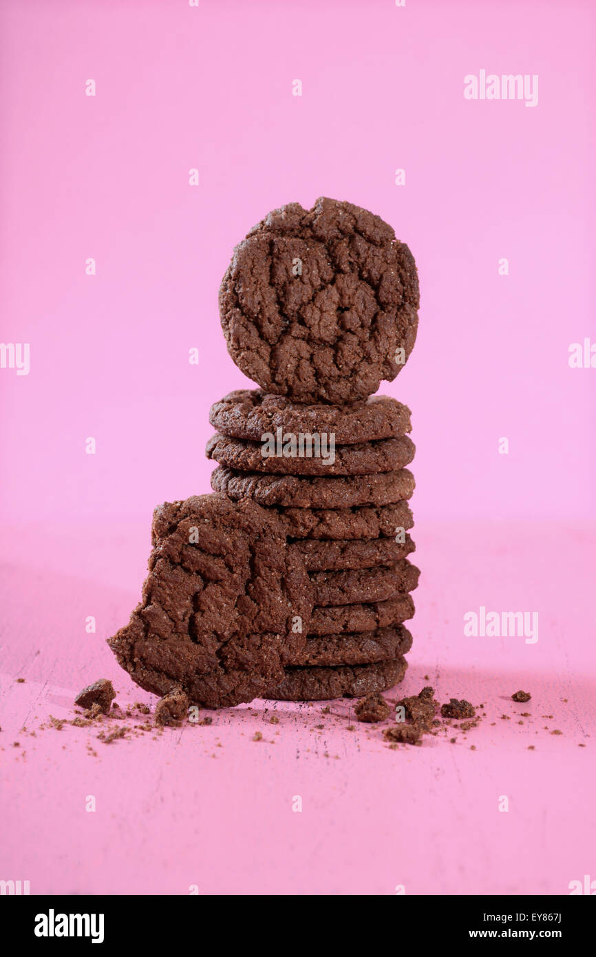 Stack of acrobatic chocolate cookies in fun compositions on wood table ...