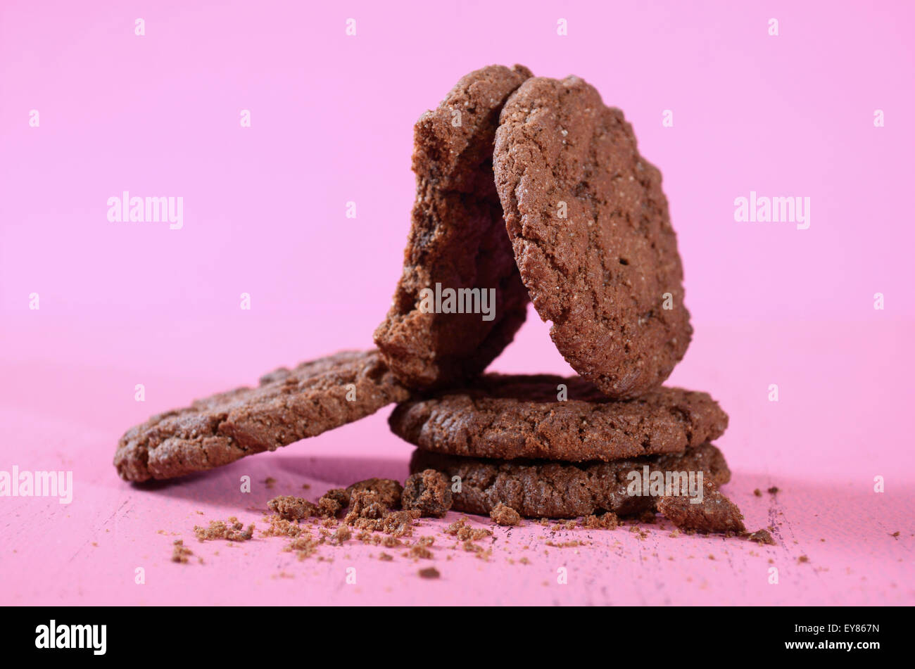 Stack of acrobatic chocolate cookies in fun compositions on wood table ...