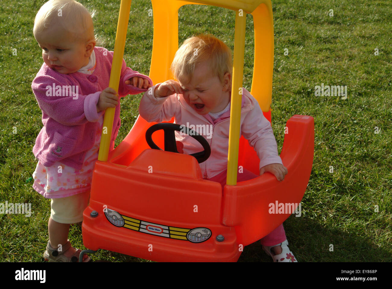 Two toddlers squabbling, one crying Stock Photo - Alamy
